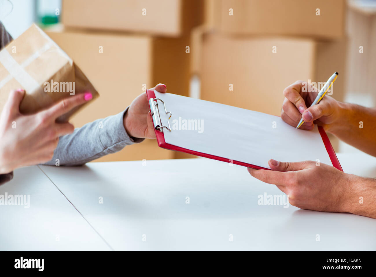 Delivery man delivering parcel box Stock Photo - Alamy