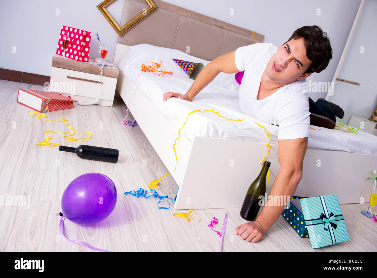 Man at home after heavy partying Stock Photo - Alamy