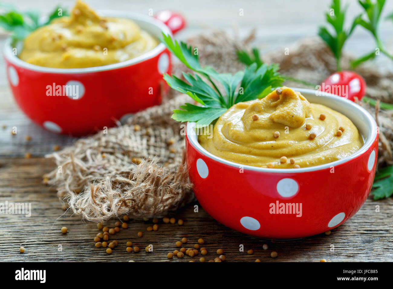 Mustard sauce and sprig of parsley in a red ceramic bowl Stock Photo ...