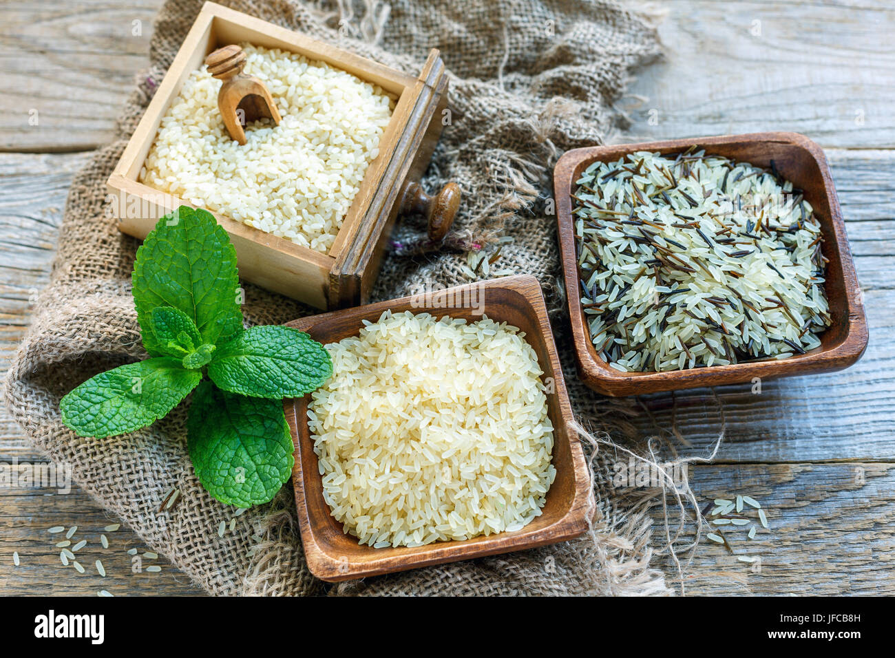 Different varieties of rice in a wooden bowl Stock Photo - Alamy