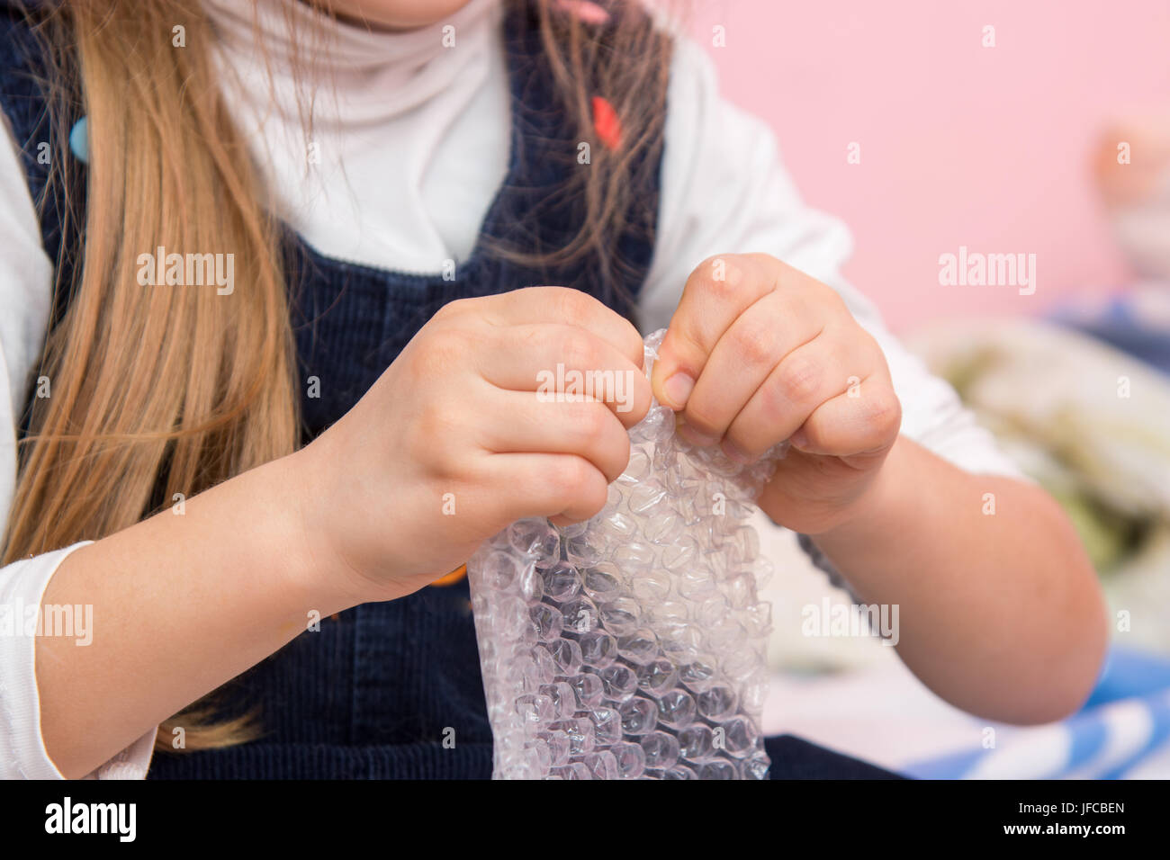 The child eats bubbles on the packaging bag Stock Photo - Alamy