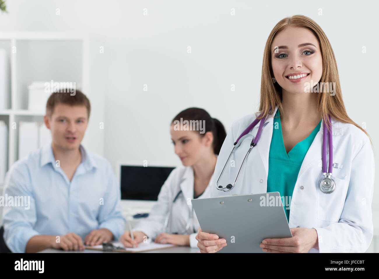 Portrait of smiling female medicine doctor with her colleague ...