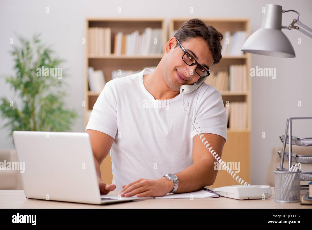 Young man working in the office Stock Photo - Alamy