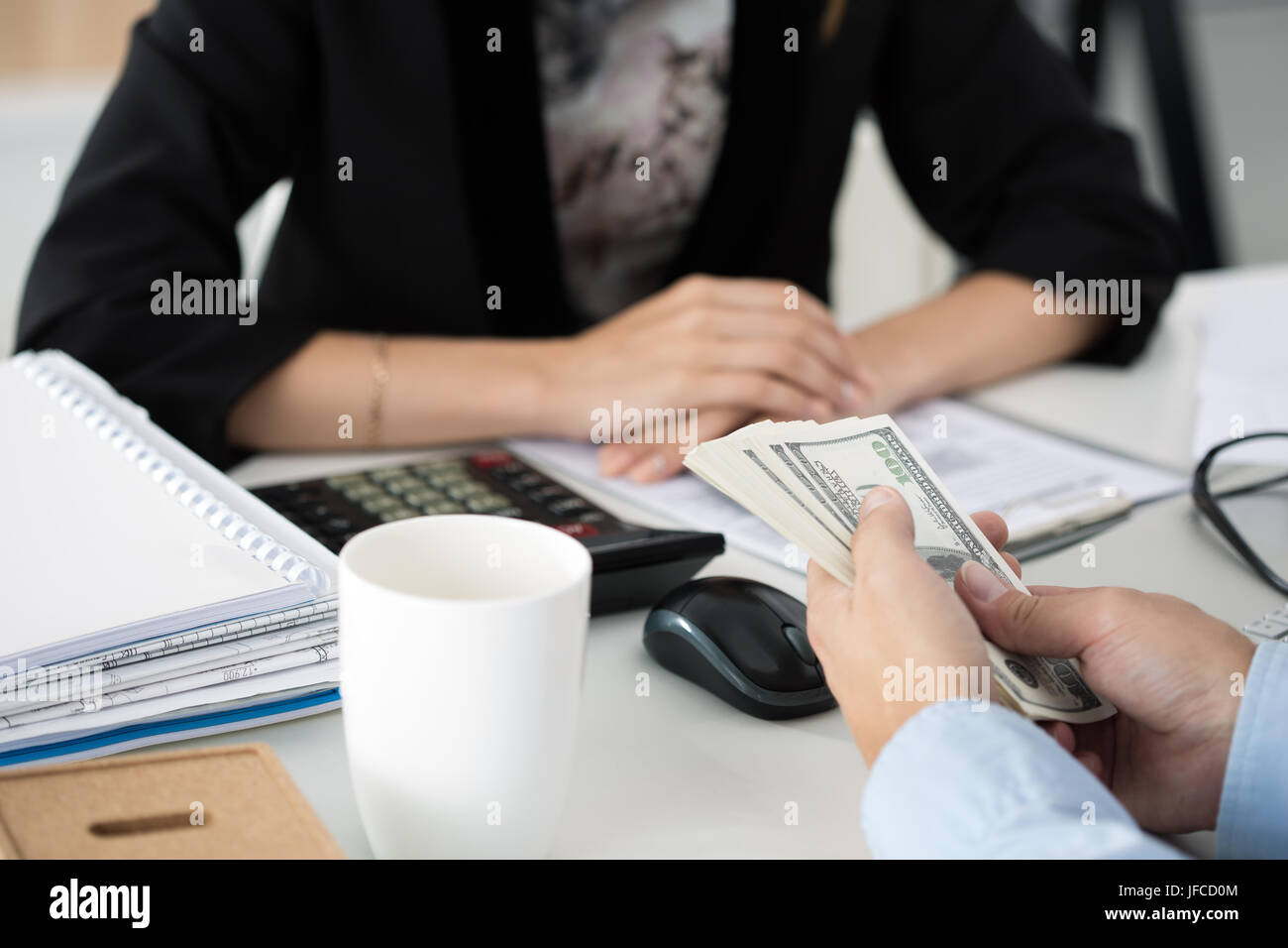 Man offering batch of hundred dollar bills. Hands close up. Venality ...