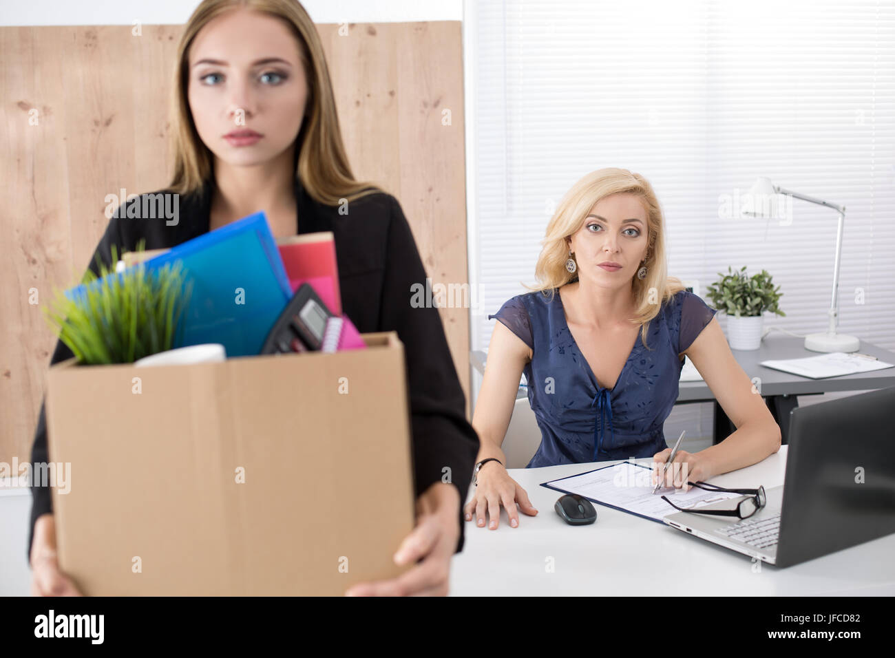 Boss dismissing an employee. Dejected fired office worker carrying a ...