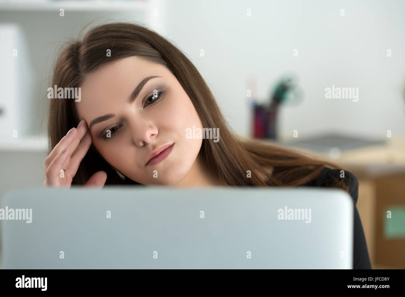 Tired female employee at workplace in office touching her head. Sleepy ...