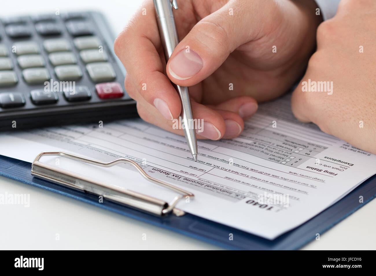 Close up of male accountant making calculations. Man writing something ...