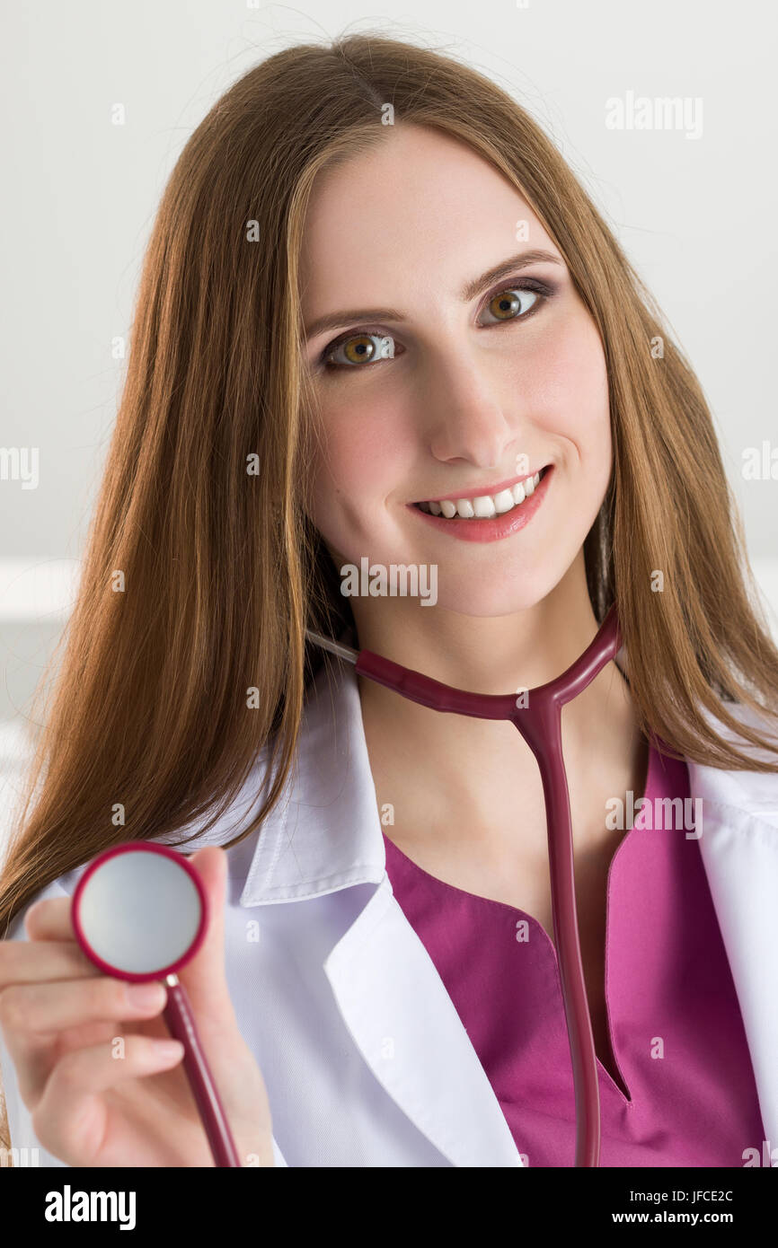 Beautiful smiling female medicine doctor holding stethoscope head ready ...