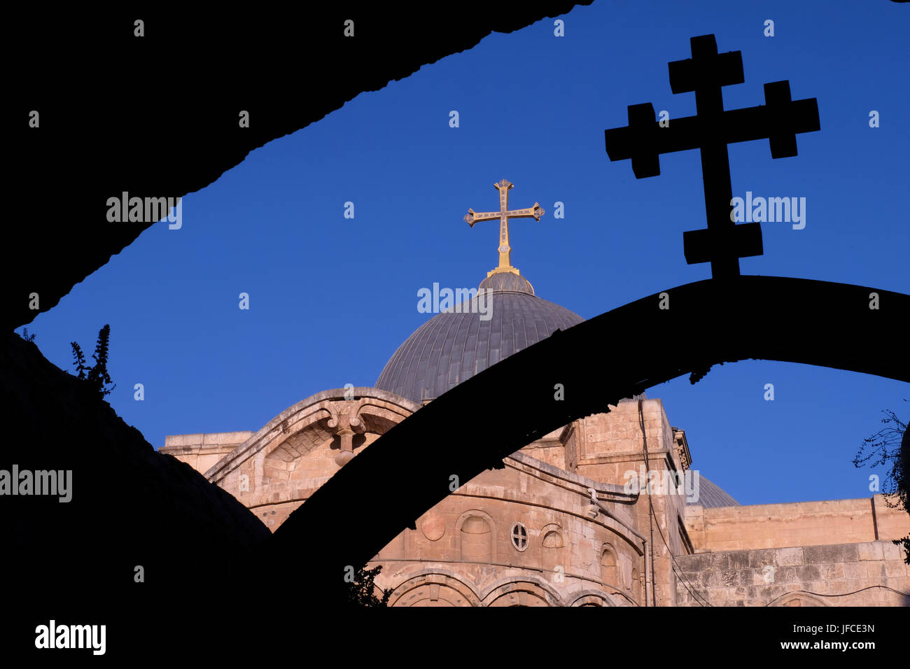 Cross crosslet over an arch in a passage leading to the Church of Holy ...