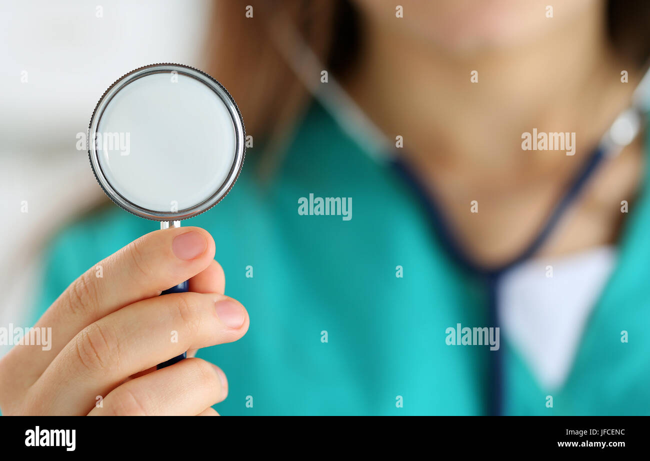 Young female medicine doctor holding stethoscope head ready to examine ...