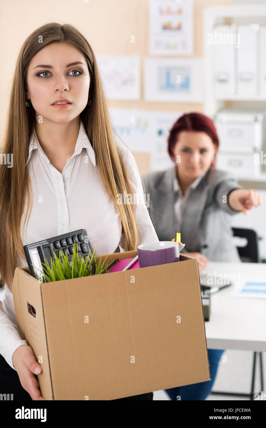 Boss dismissing an employee. Dejected fired office worker carrying a ...