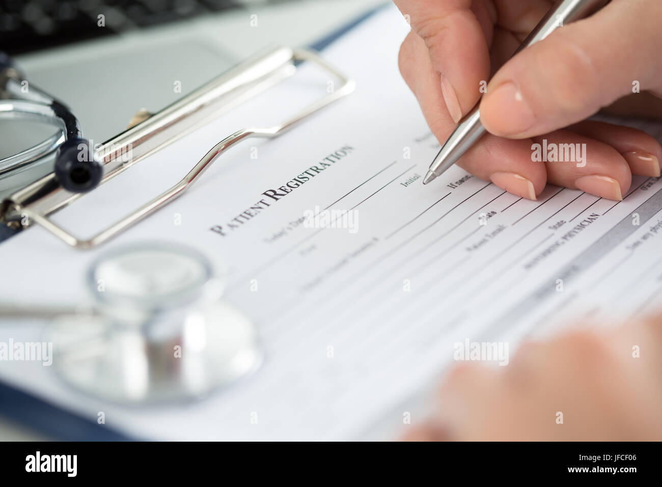 Close up view of female medicine doctors hands filling patient medical ...