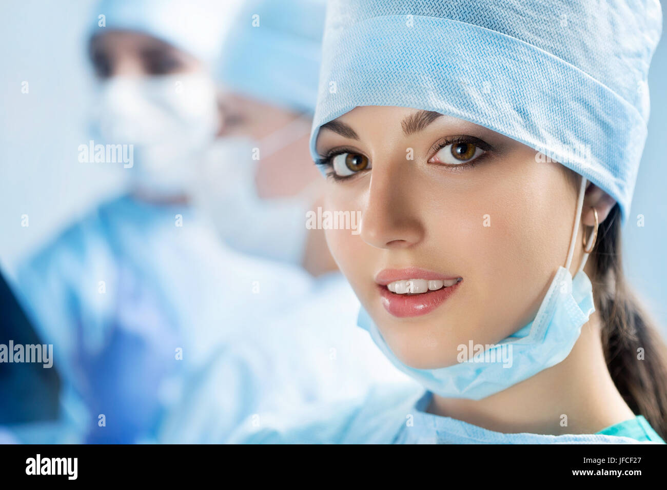 Portrait of happy young female surgeon or intern after successful ...