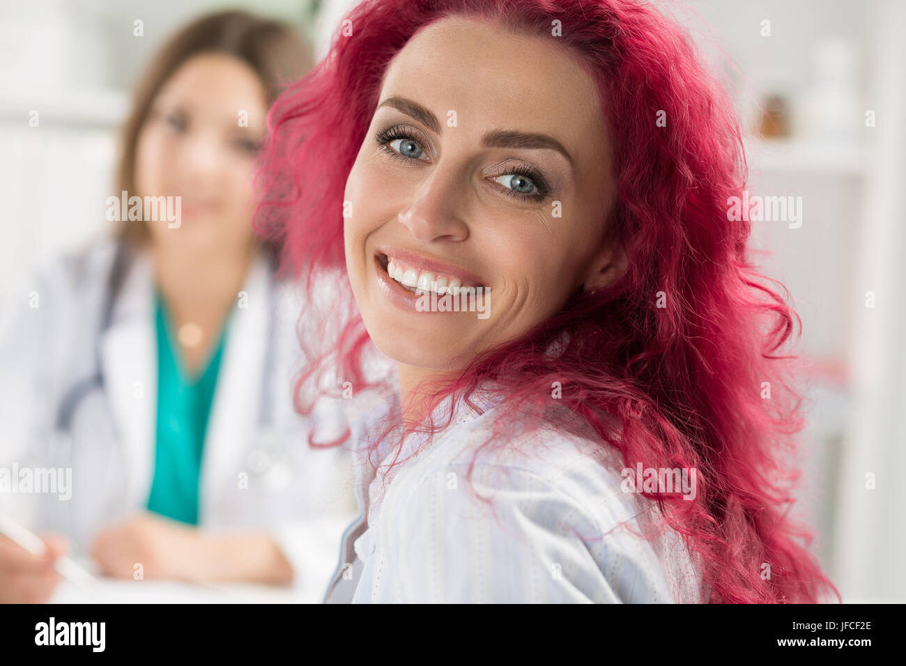 Smiling happy female patient sitting at medicine doctor office. Medical ...