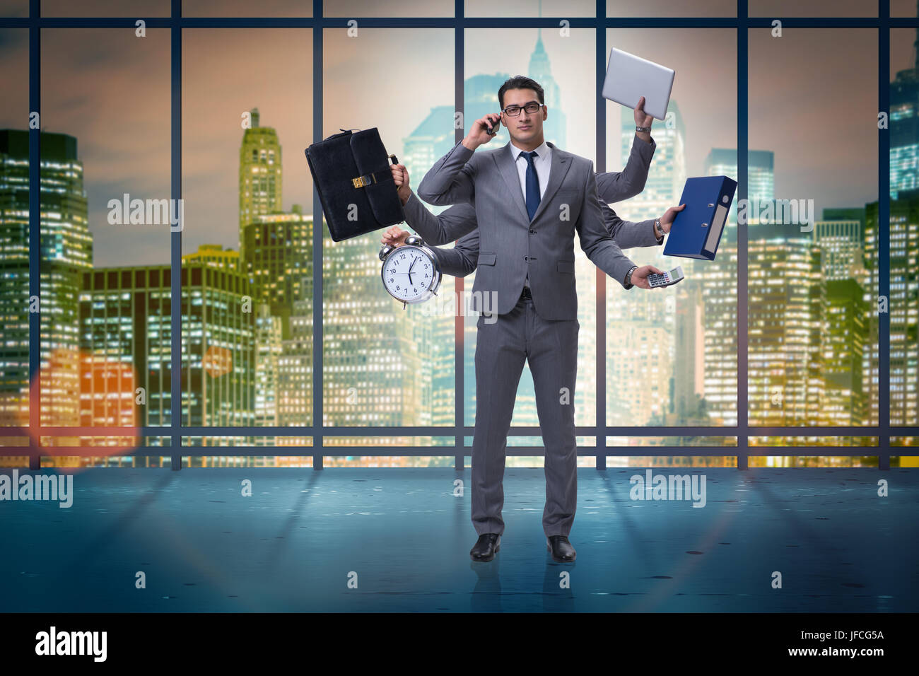 Young businessman in multitasking concept Stock Photo - Alamy