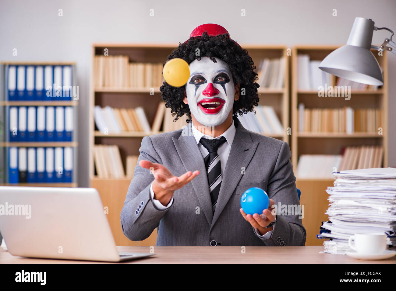 Clown businessman working in the office Stock Photo - Alamy