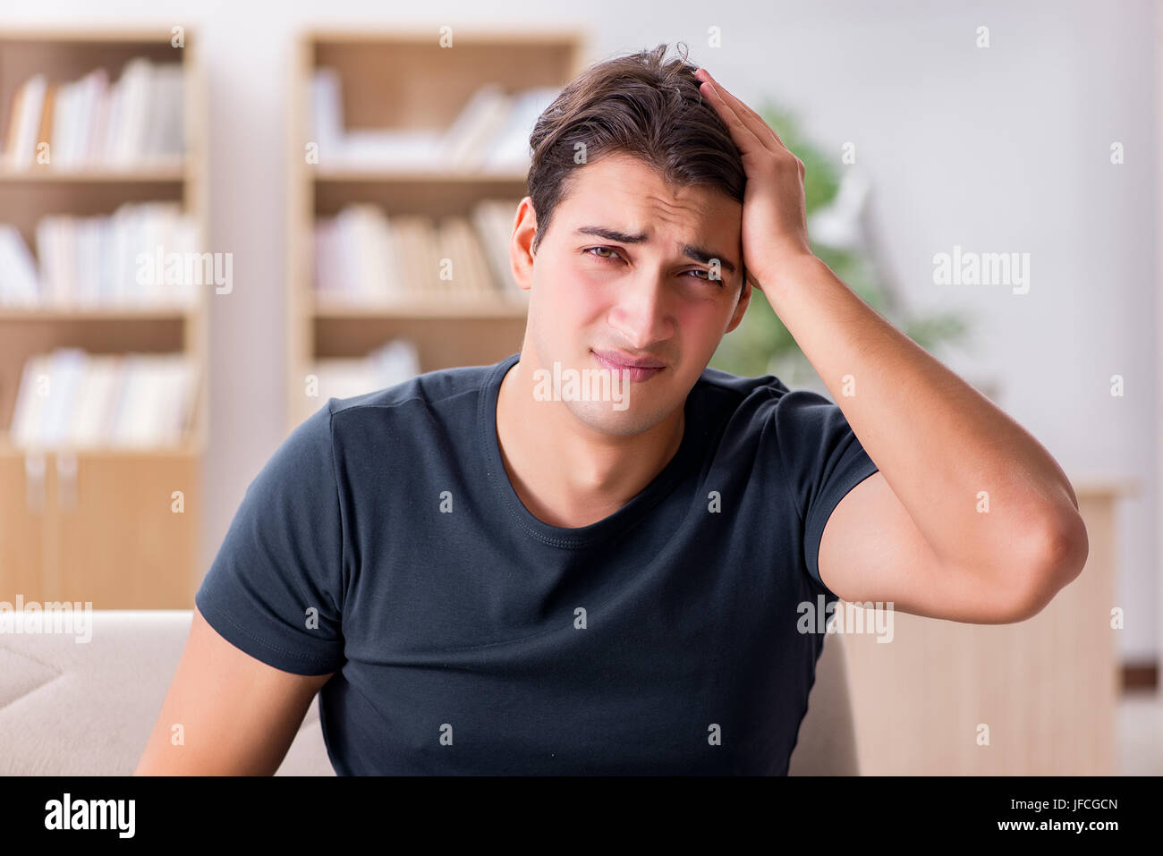 Young handsome man suffering from pain Stock Photo - Alamy