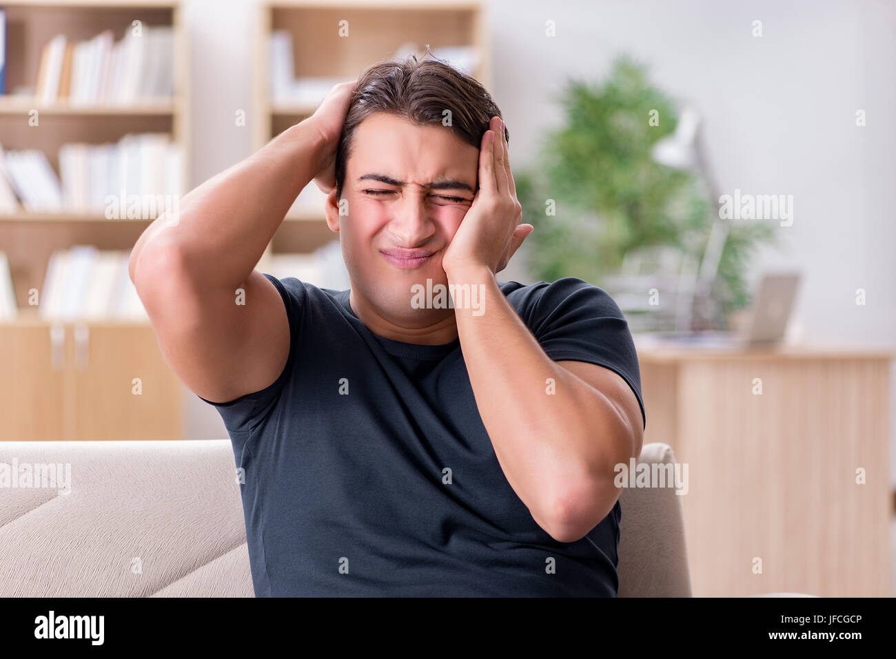 Young handsome man suffering from pain Stock Photo - Alamy