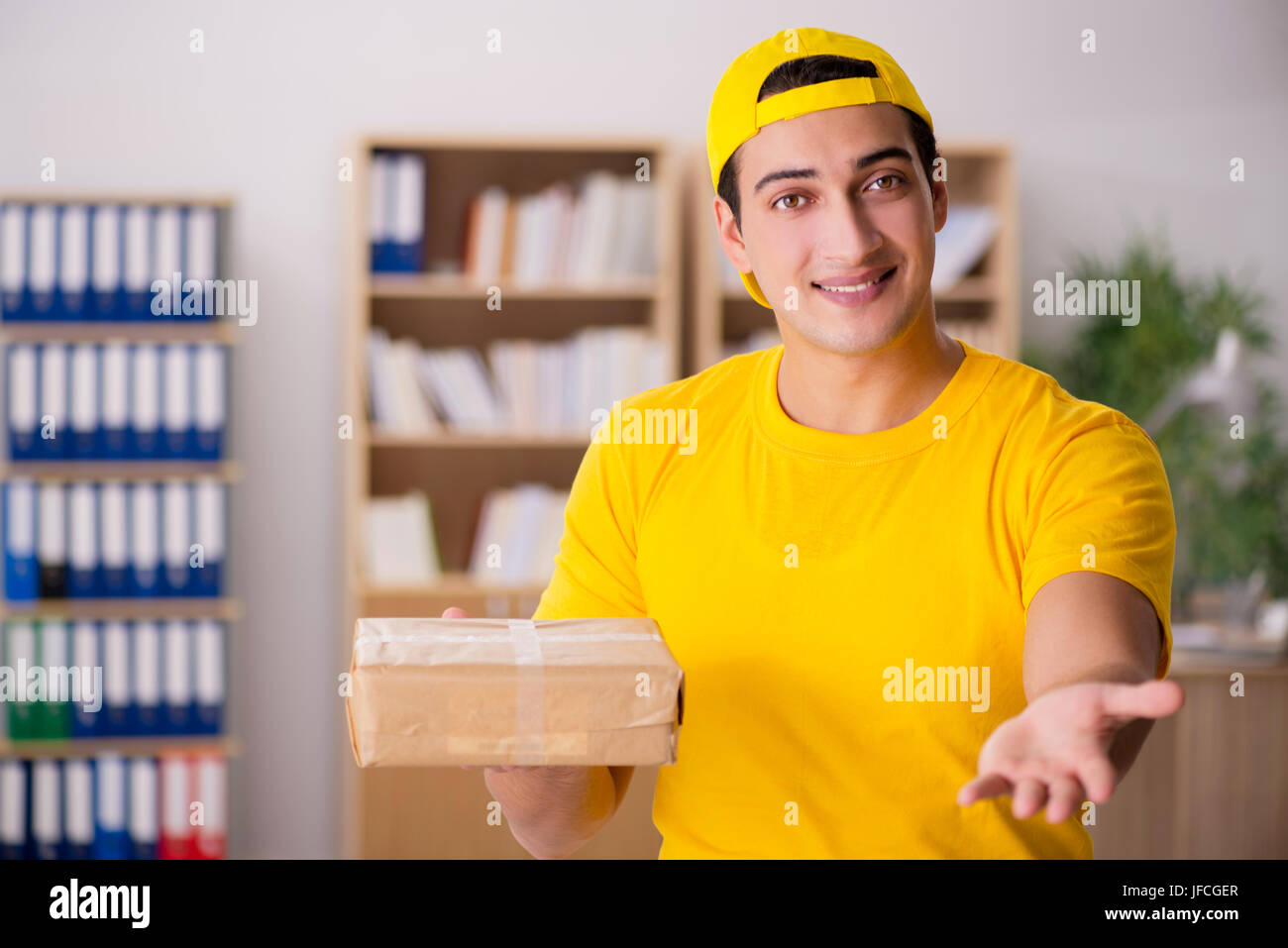 Delivery man delivering parcel box Stock Photo - Alamy