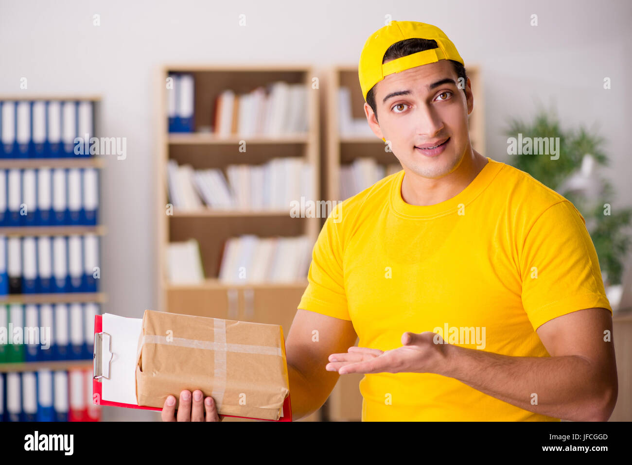 Delivery man delivering parcel box Stock Photo - Alamy