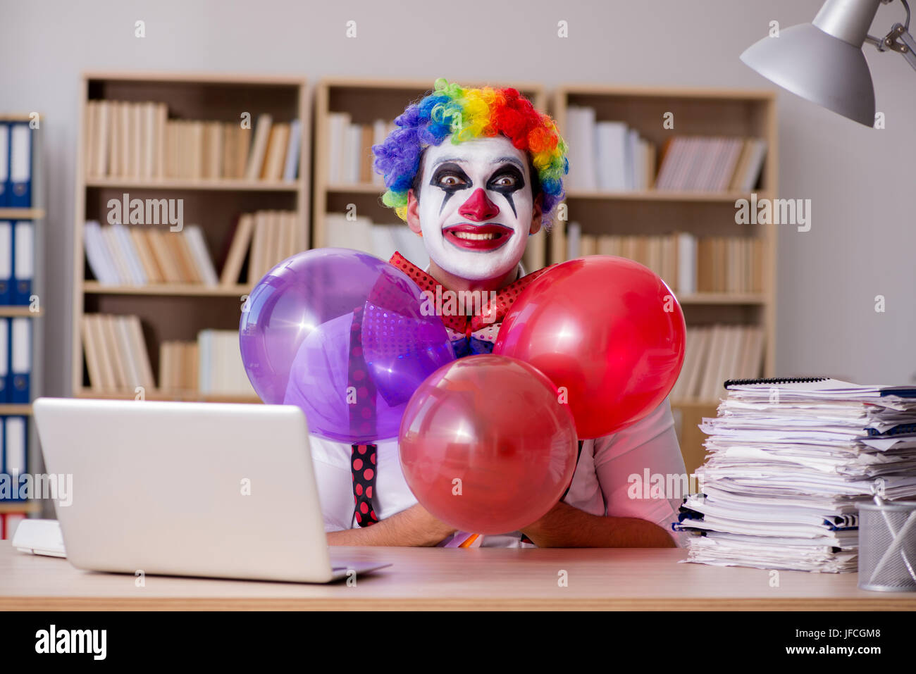 Clown businessman working in the office Stock Photo - Alamy