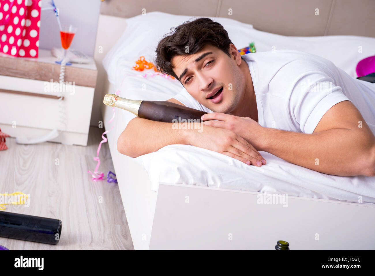Man at home after heavy partying Stock Photo - Alamy
