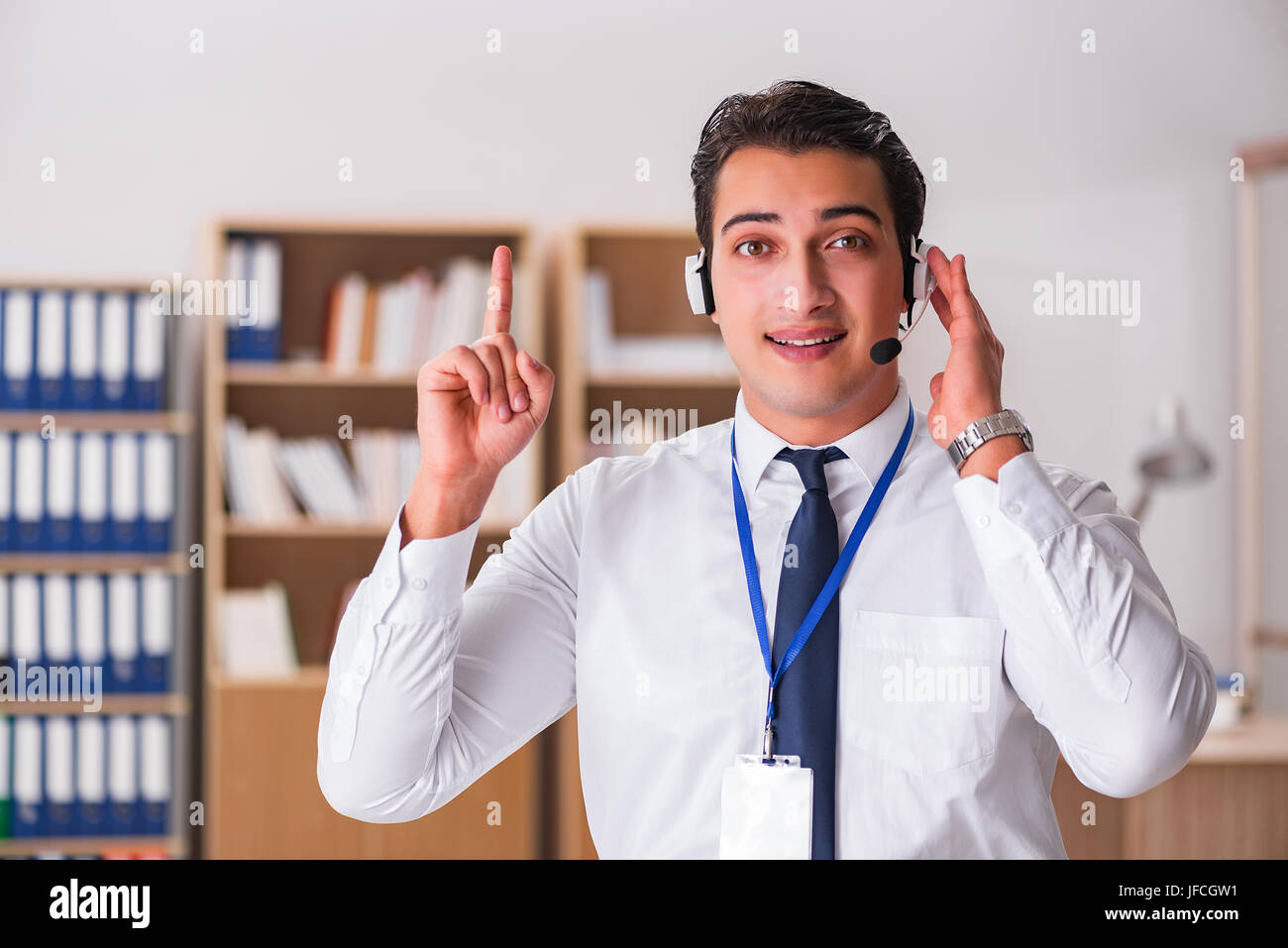 Handsome customer service clerk with headset Stock Photo - Alamy