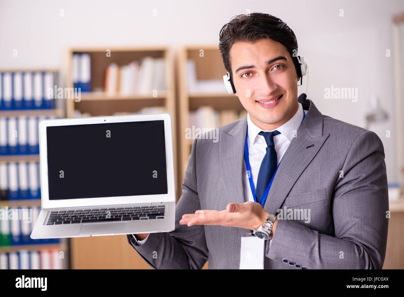 Handsome customer service clerk with headset Stock Photo - Alamy