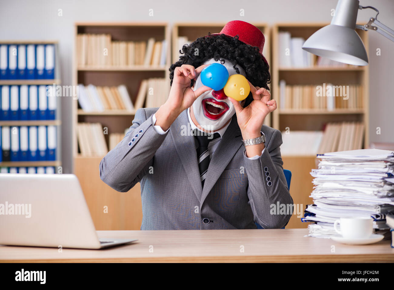 Clown businessman working in the office Stock Photo - Alamy