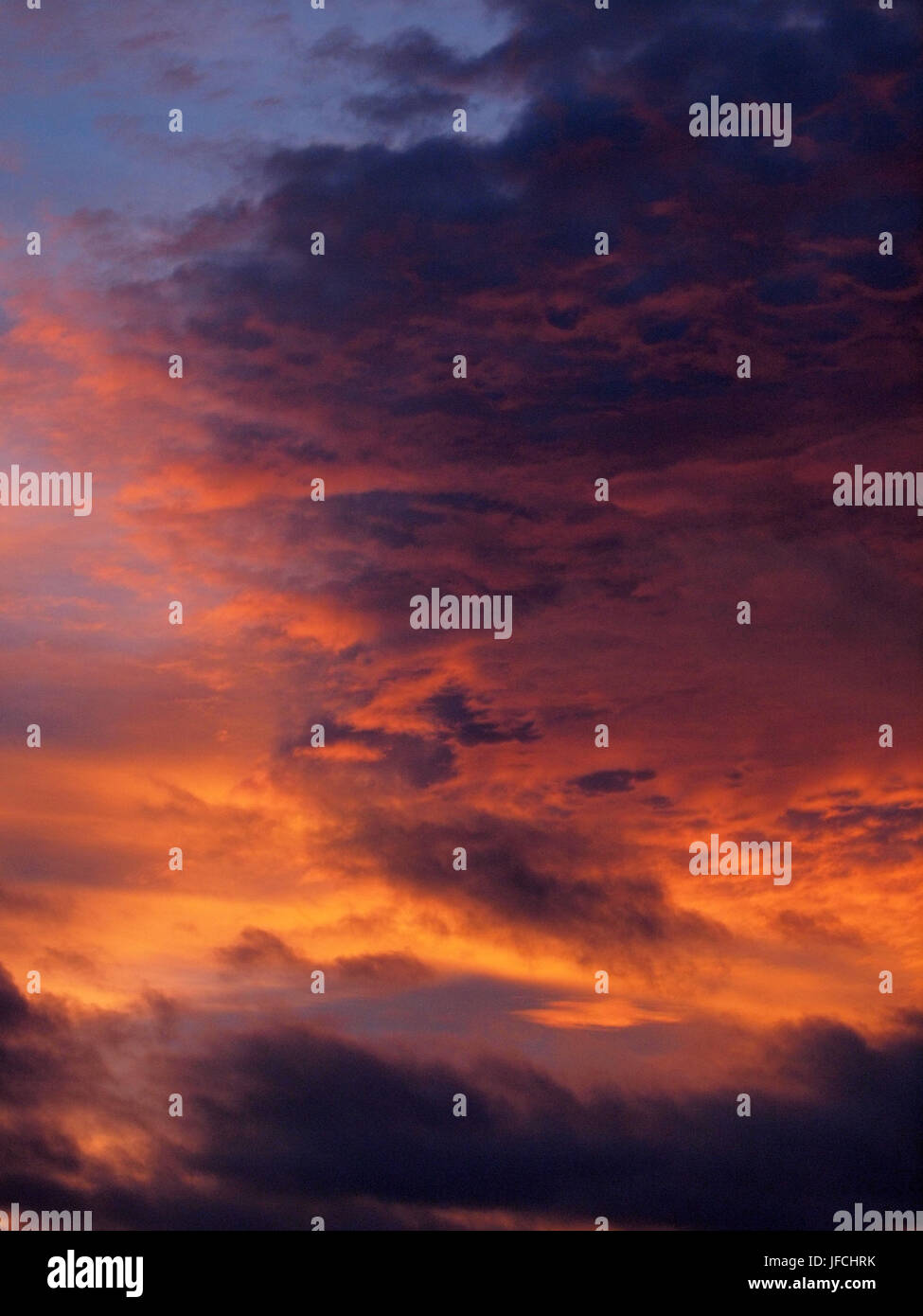 Dramatic red sky reflected off clouds Stock Photo - Alamy