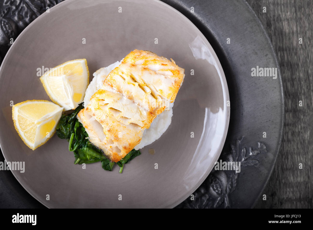 Fried cod fillets and spinach Stock Photo - Alamy