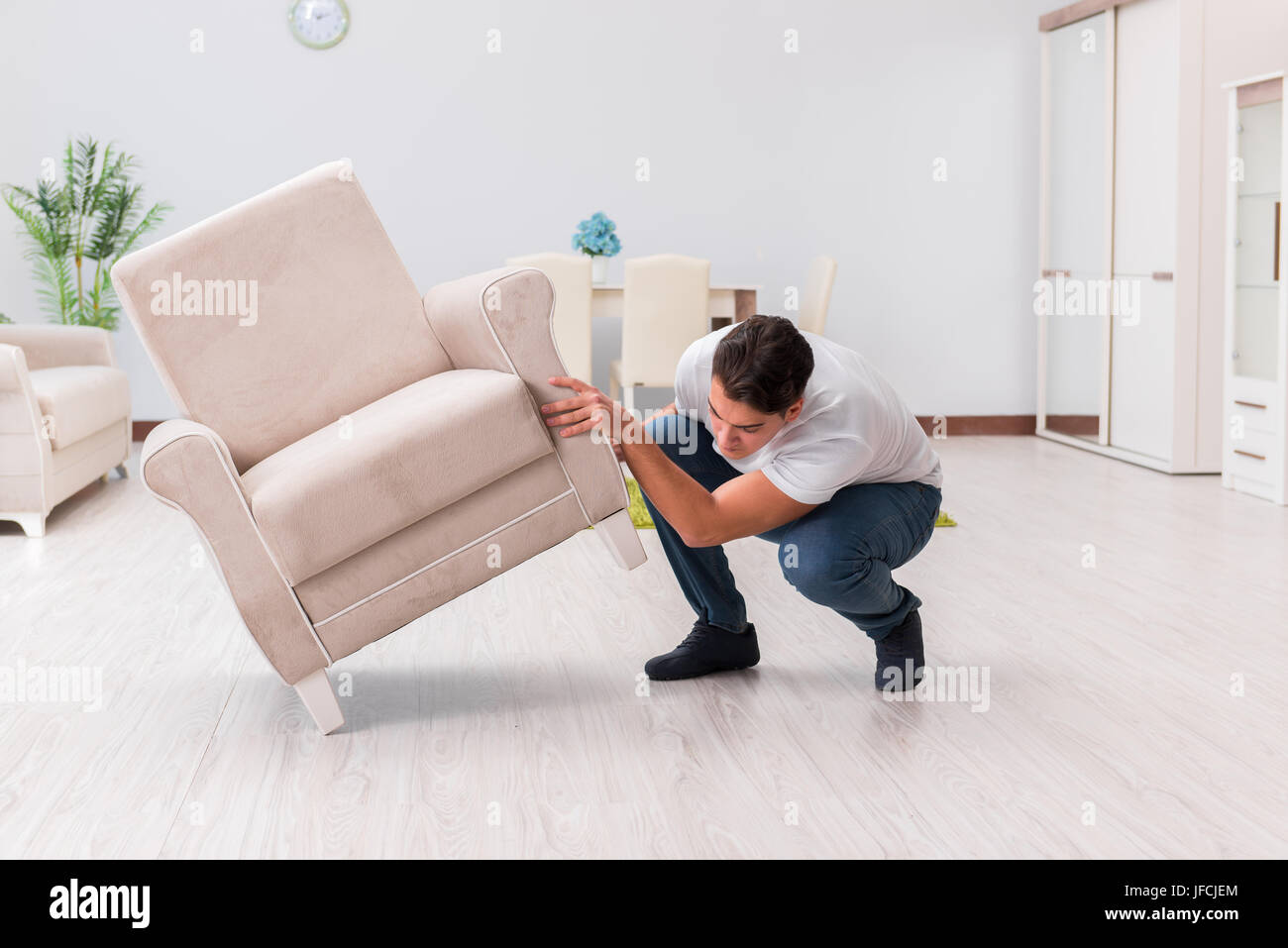 Man moving furniture at home Stock Photo - Alamy