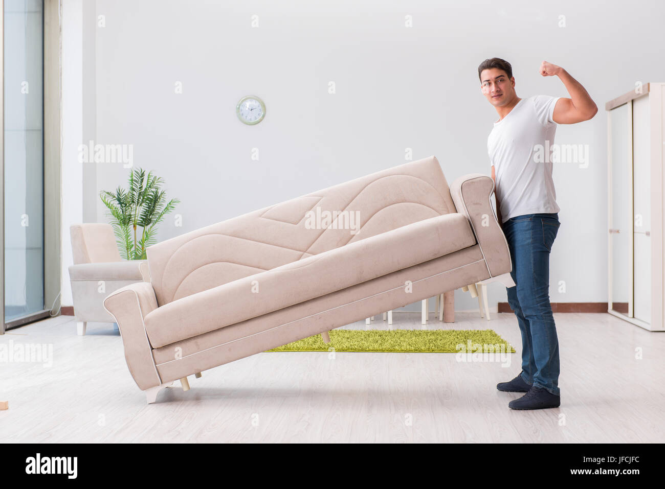 Man moving furniture at home Stock Photo - Alamy