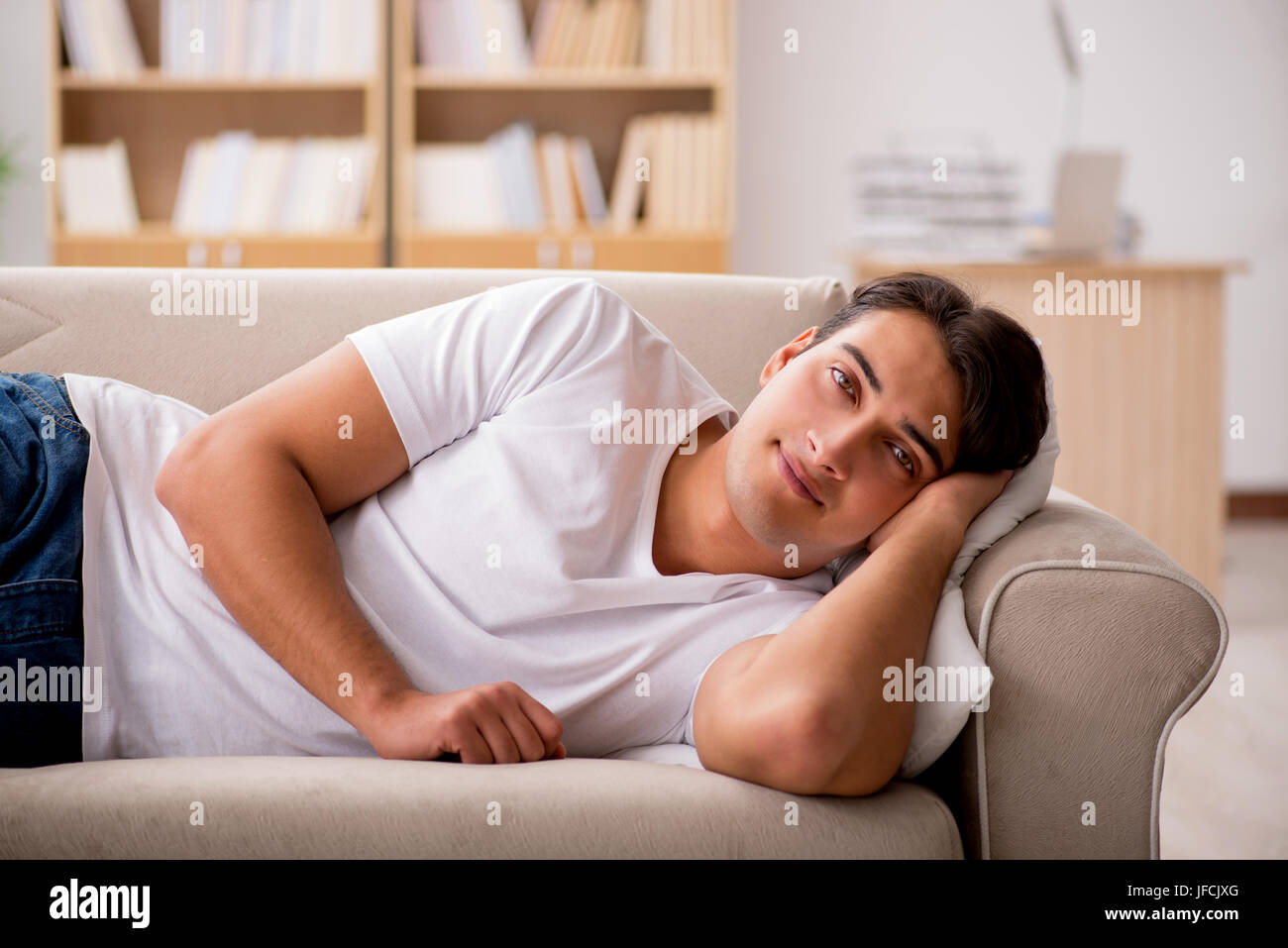 Young man sleeping in sofa couch Stock Photo - Alamy