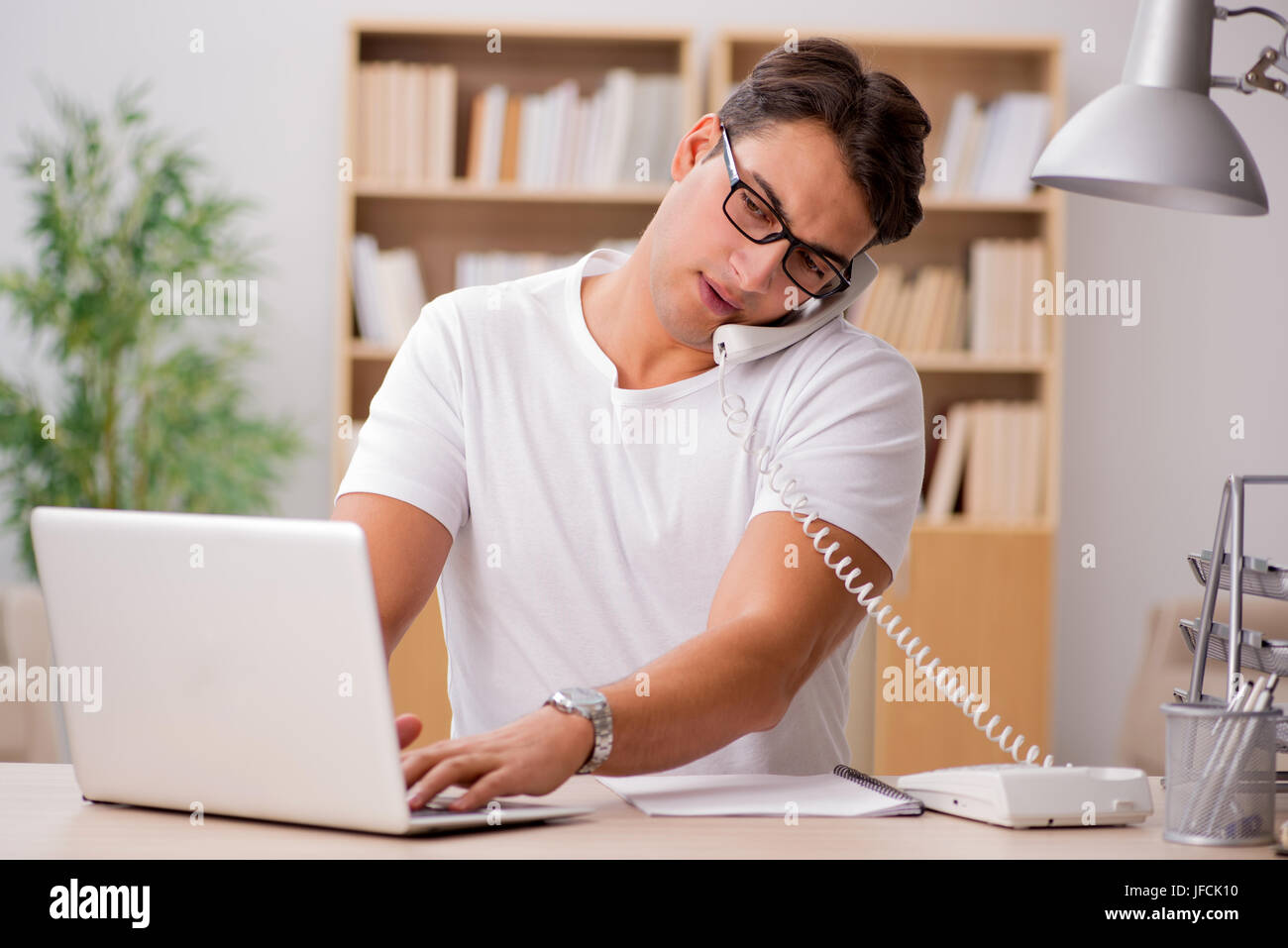 Young man working in the office Stock Photo - Alamy