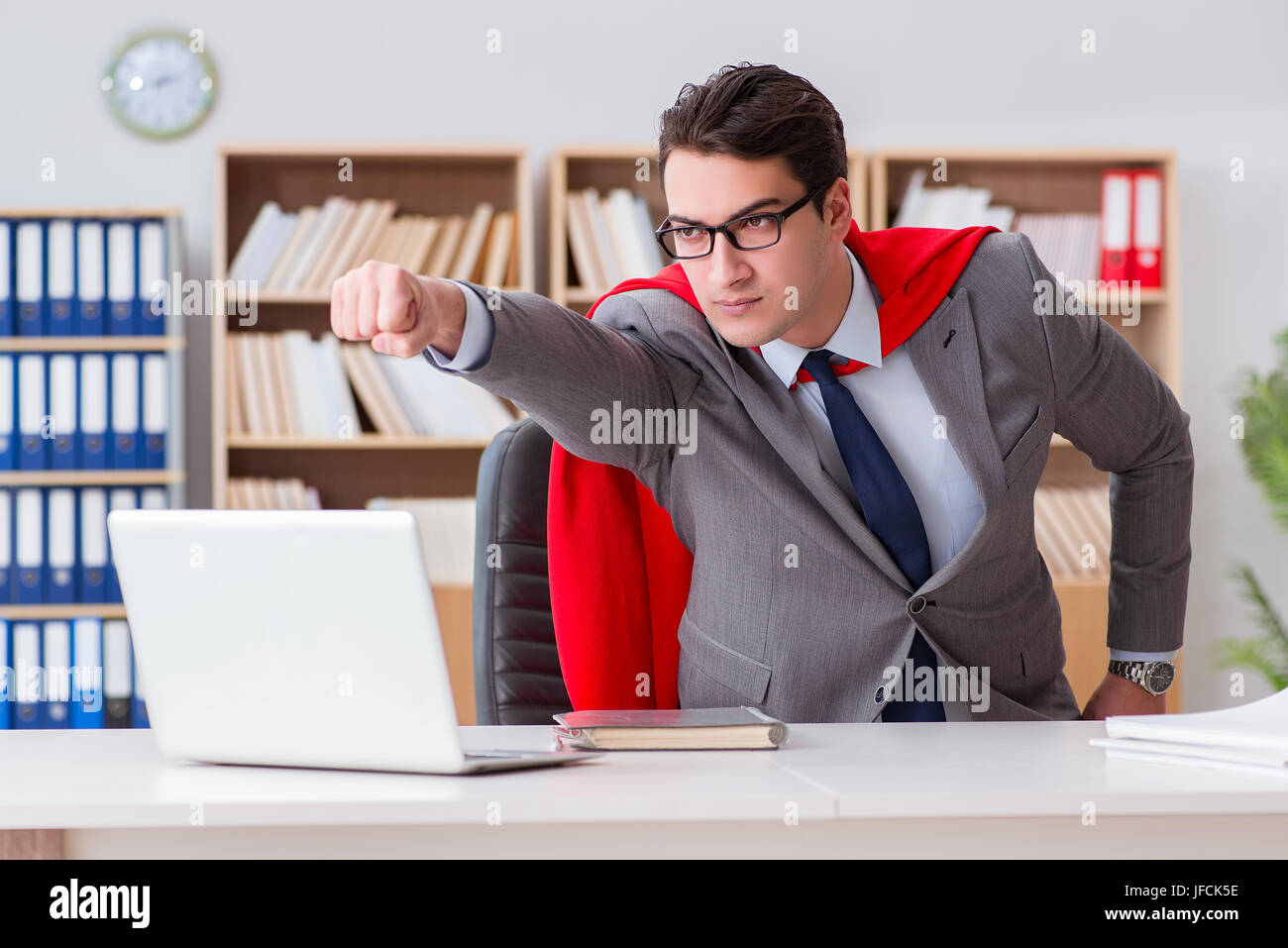 Superhero businessman working in the office Stock Photo - Alamy