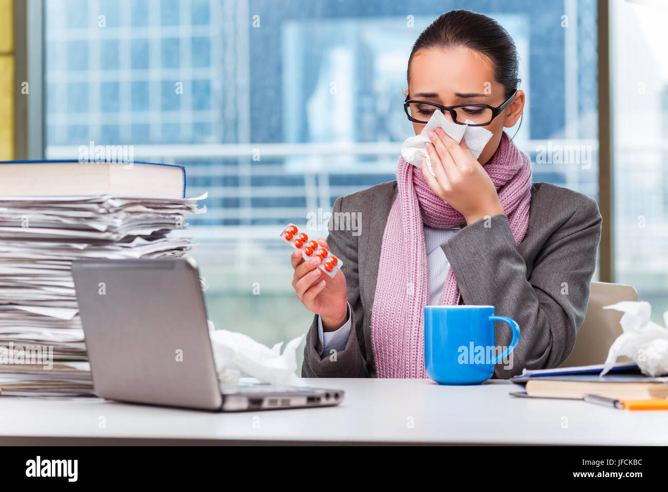 Young businesswoman sick in the office Stock Photo - Alamy