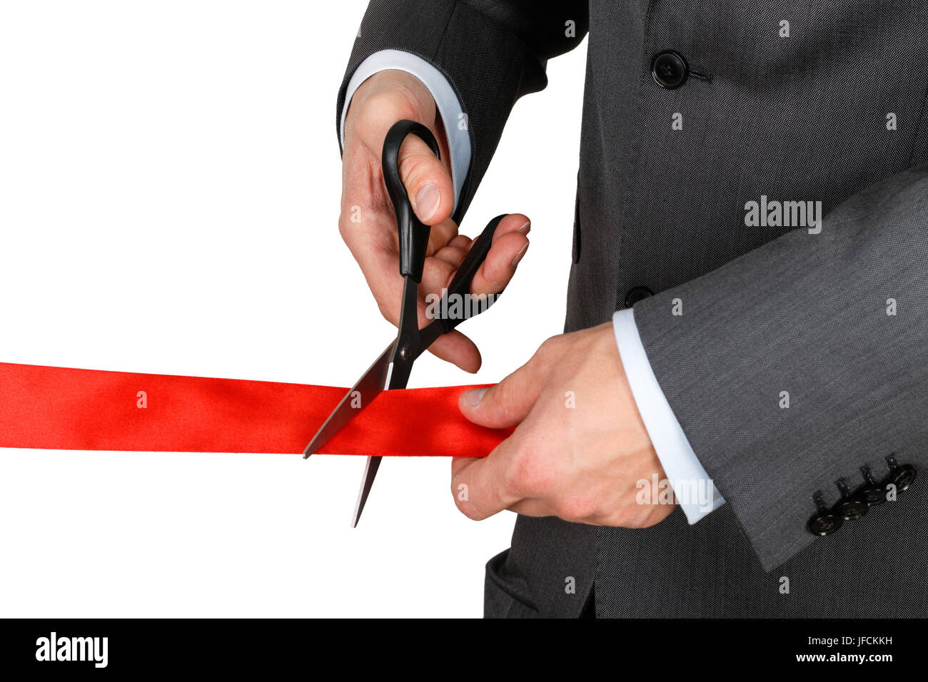 Businessman in suit cutting red ribbon with pair of scissors isolated ...