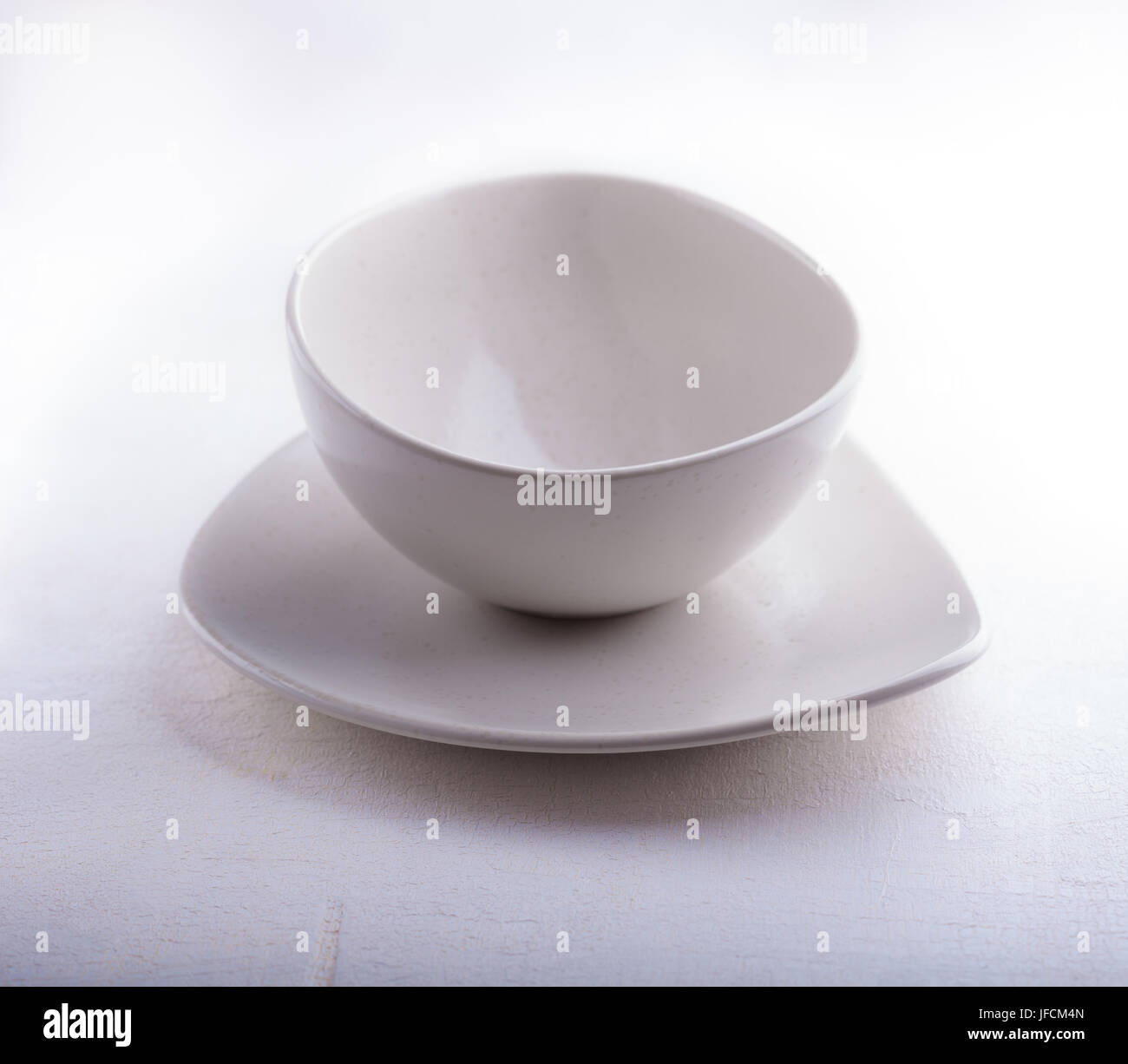 Two Empty bowls placed on a white surface Stock Photo - Alamy