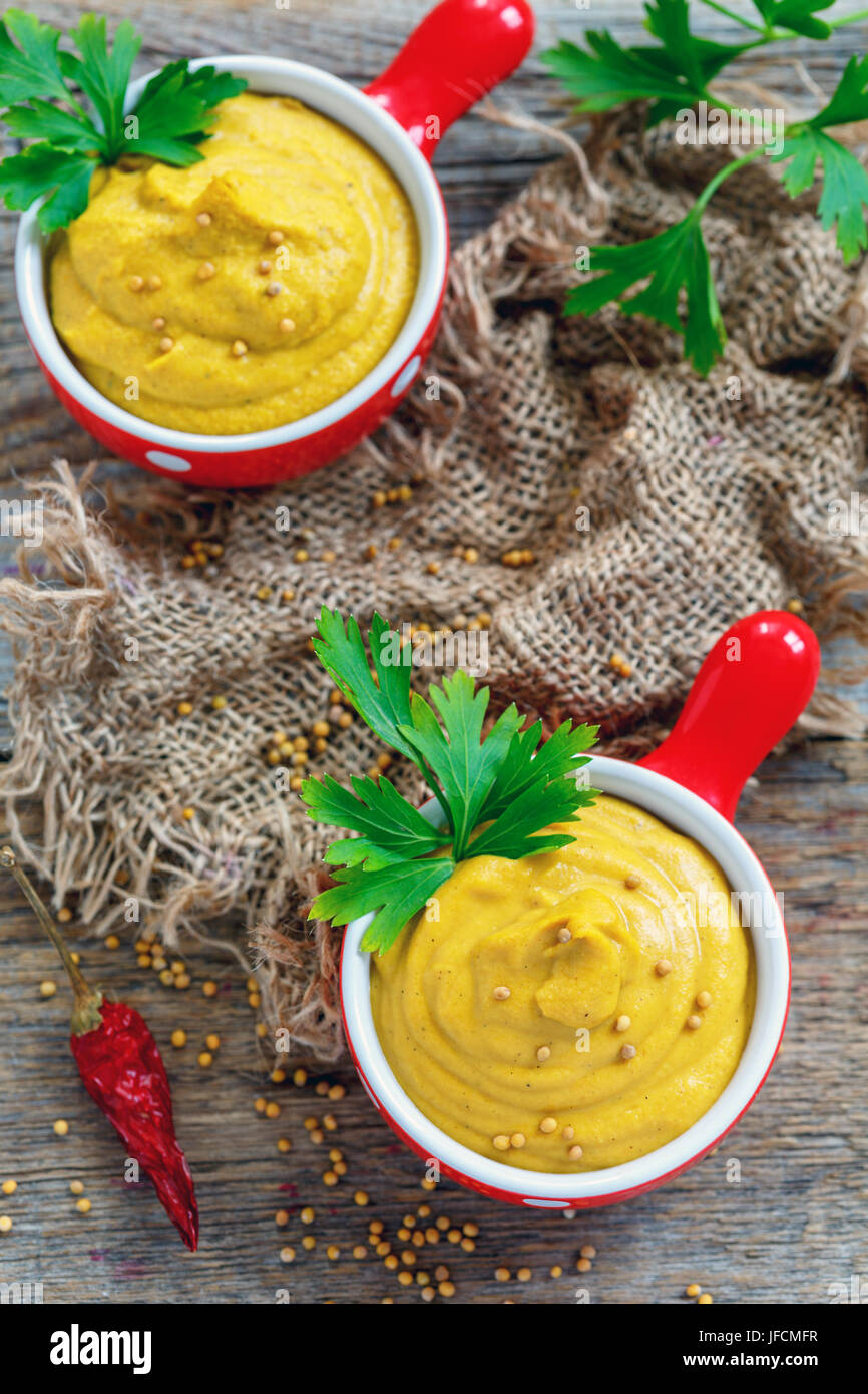 Mustard sauce and parsley in a red ceramic bowl Stock Photo - Alamy