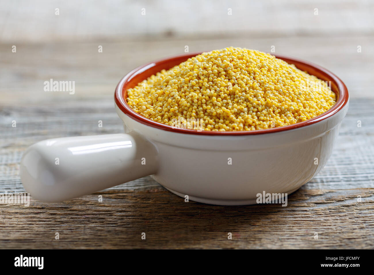 Organic dried millet in a ceramic bowl Stock Photo - Alamy
