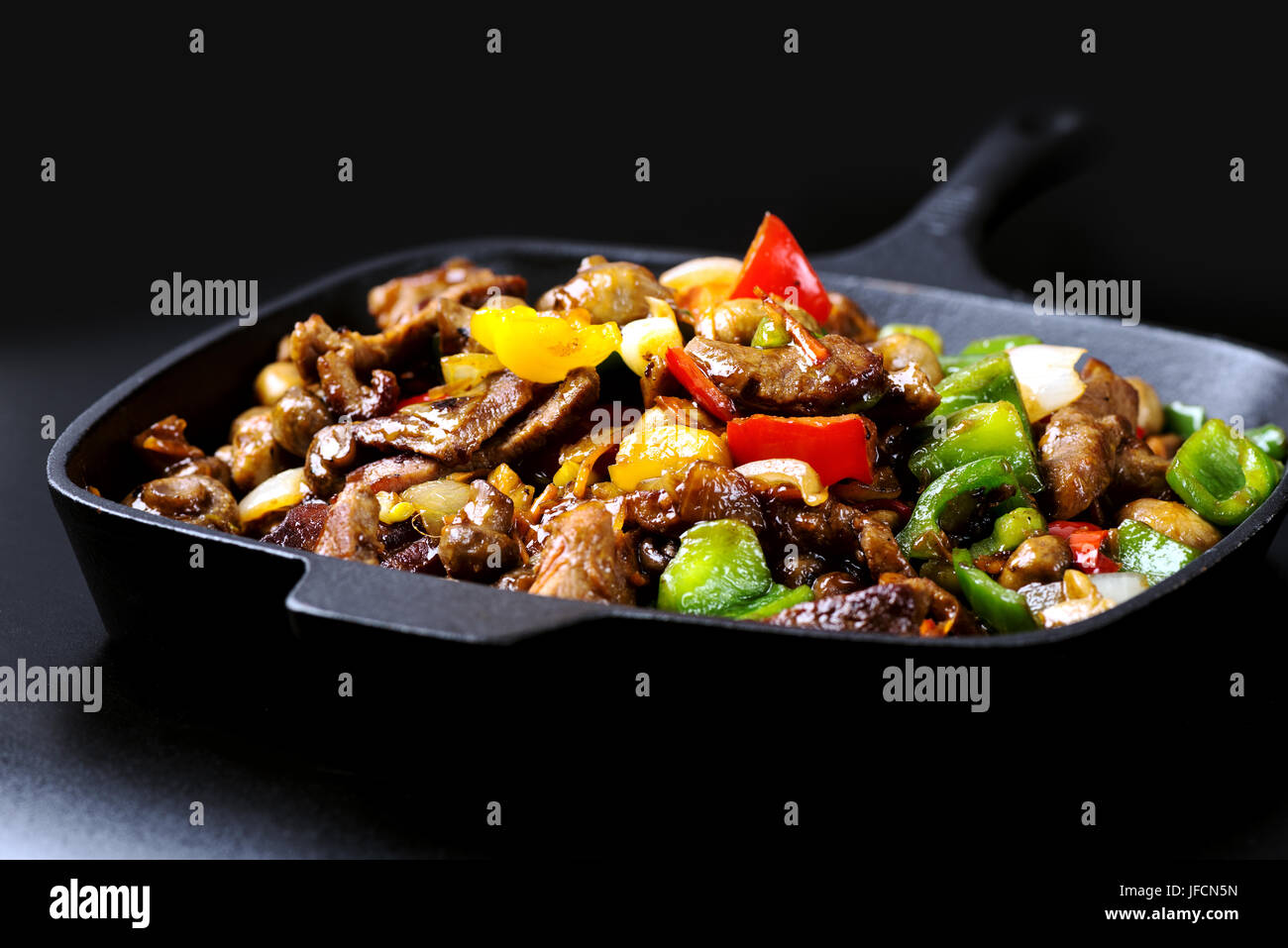 food in iron cast skillet Stock Photo - Alamy
