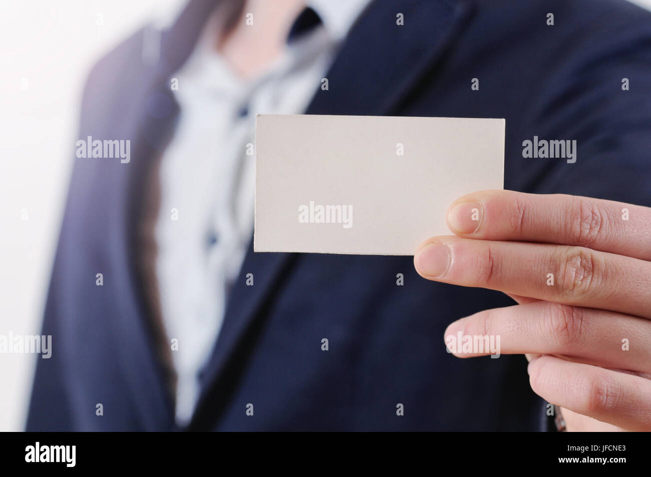 Man's hand showing business card - closeup shot on white background ...