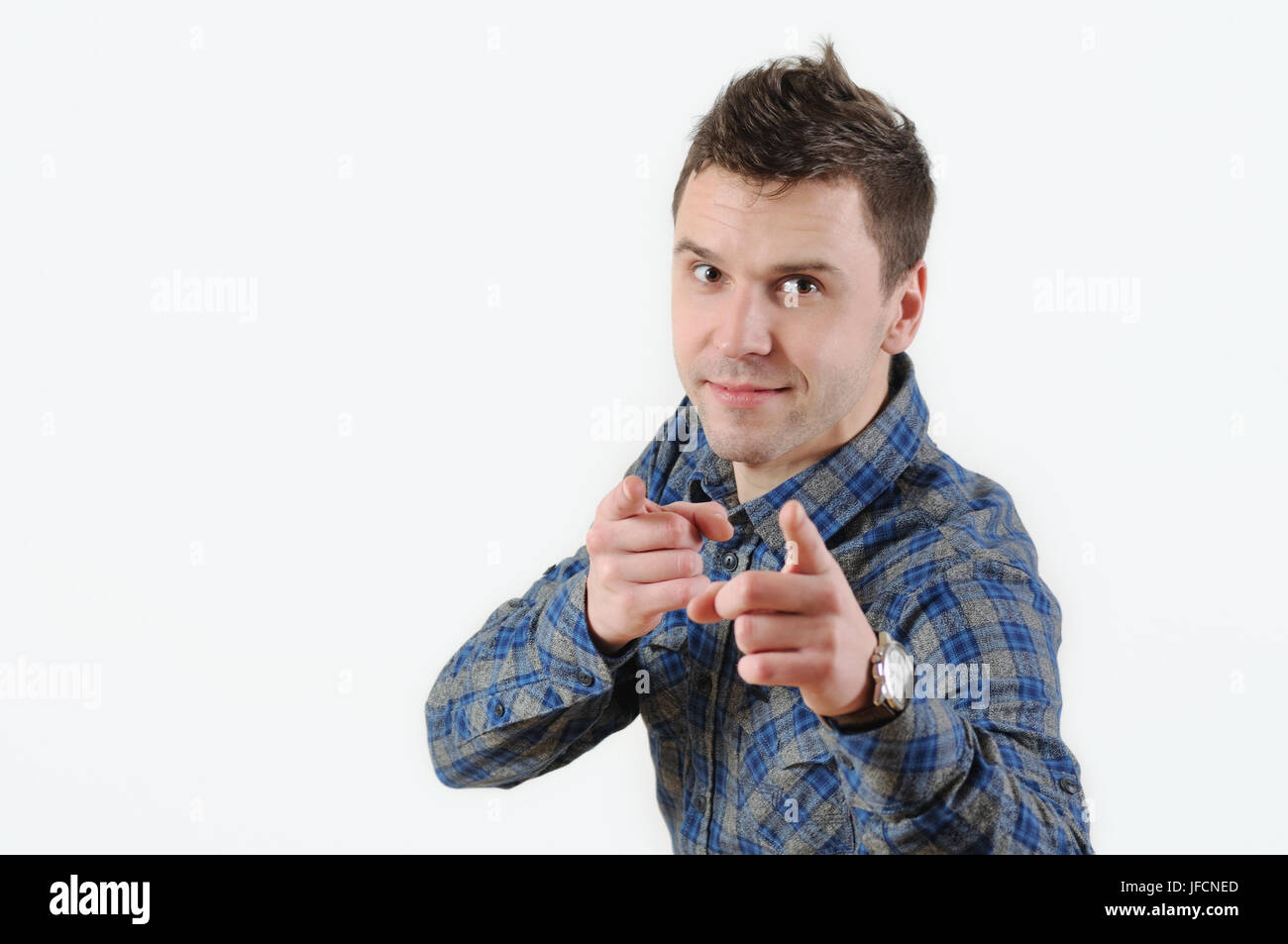 Portrait handsome young smiling man giving thumbs up pointing fingers ...