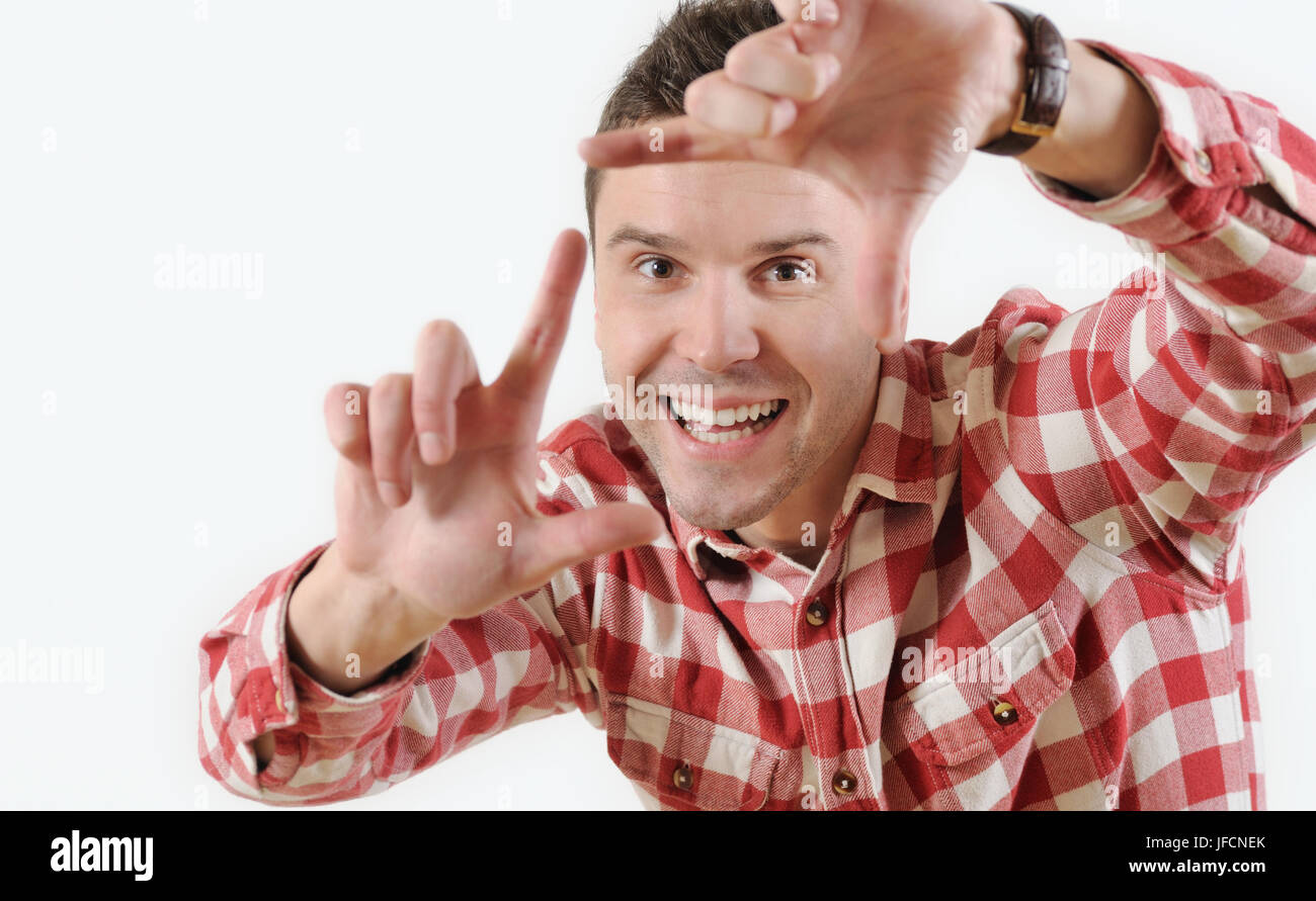portrait young man showing finger frame looking at camera on white ...