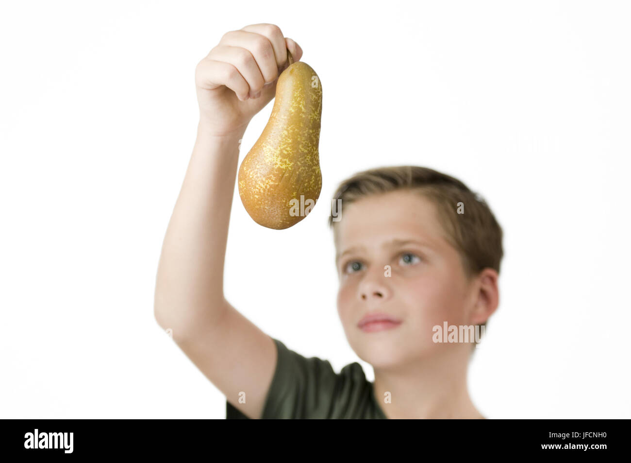 Boy holding up a pear on white Stock Photo - Alamy