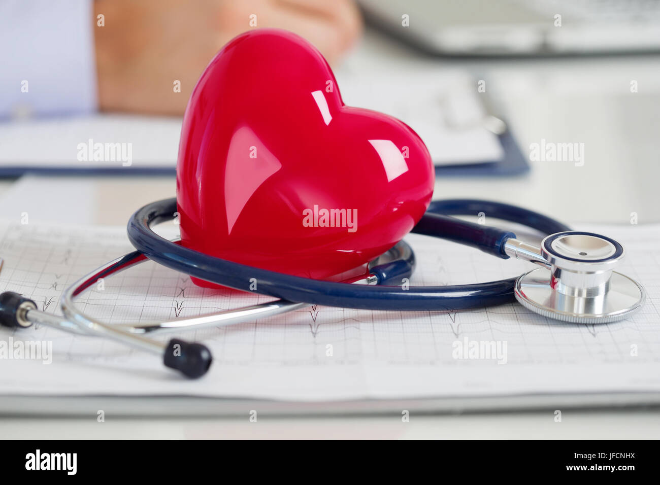 Read heart and stethoscope laying on cardiogram chart at doctor's ...
