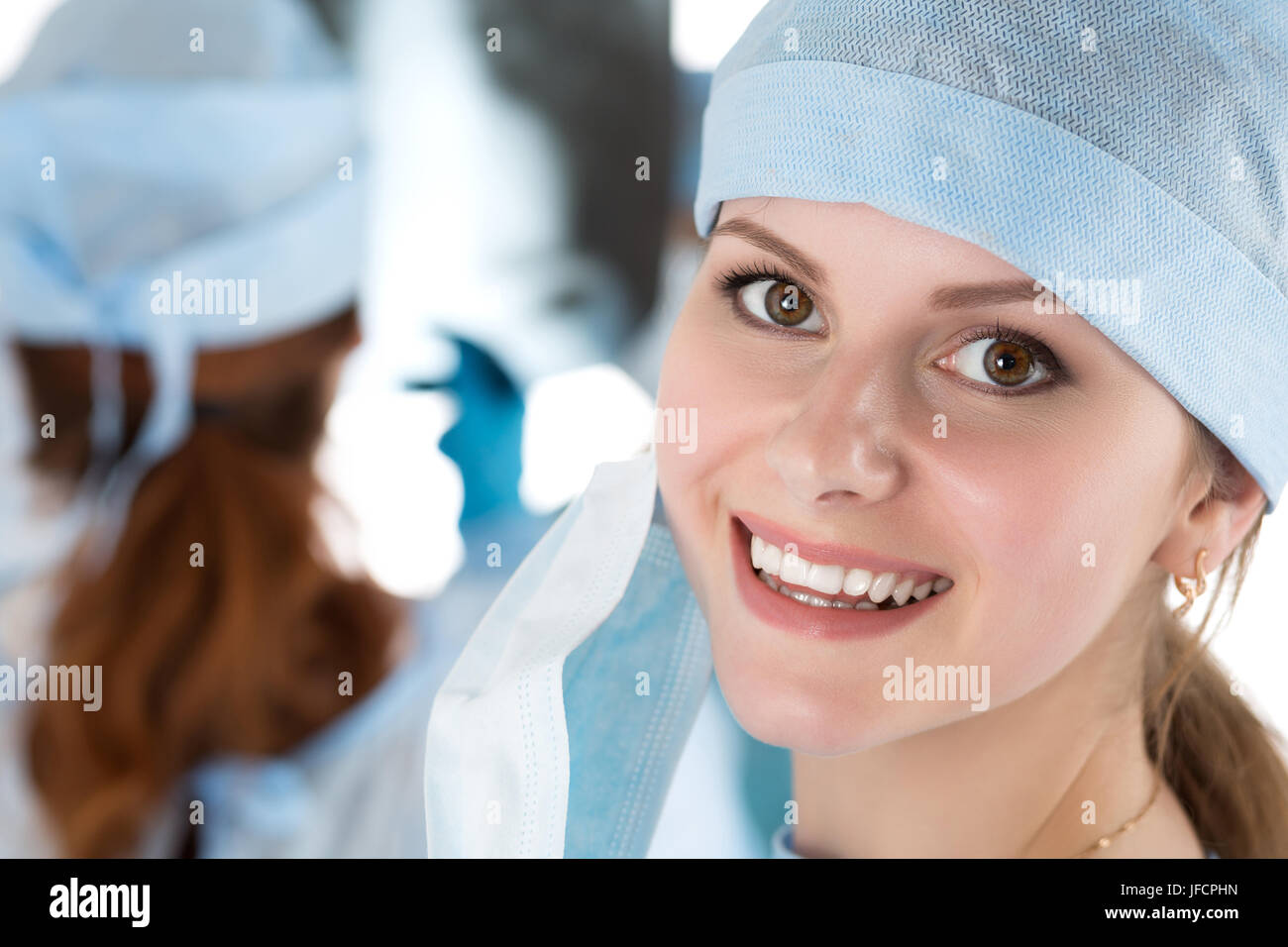 Portrait of happy young female surgeon or intern after successful ...