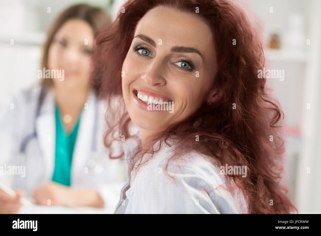 Smiling happy female patient sitting at medicine doctor office. Medical ...