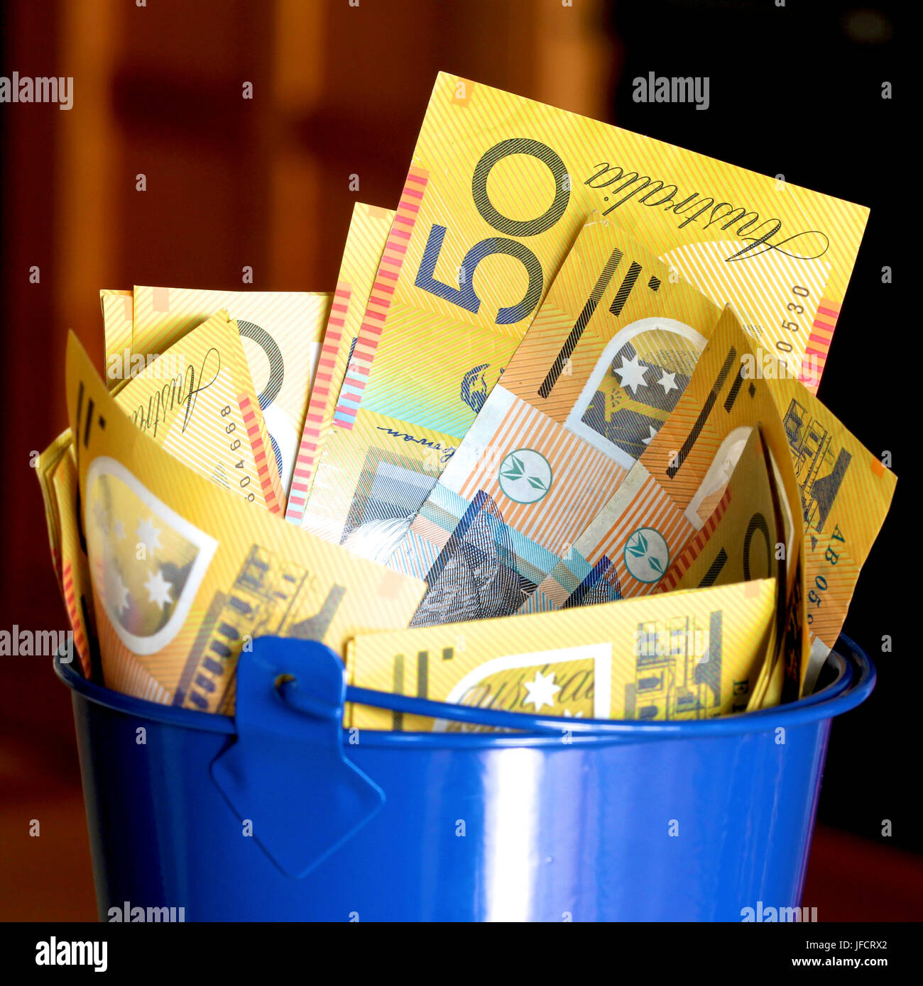Australian fifty dollar notes in a blue bucket Stock Photo - Alamy